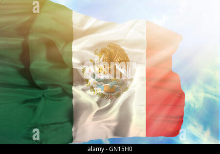 Mexico waving flag against blue sky with sunrays Stock Photo - Alamy