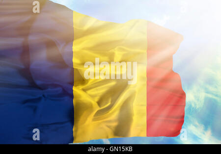 Romania waving flag against blue sky Stock Photo - Alamy