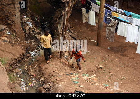 KENYA, Nairobi, Kibera slum, water hose and sewage / KENIA, Nairobi ...