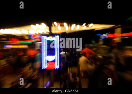 A beautiful shot of a fast moving red train at night at a station in ...
