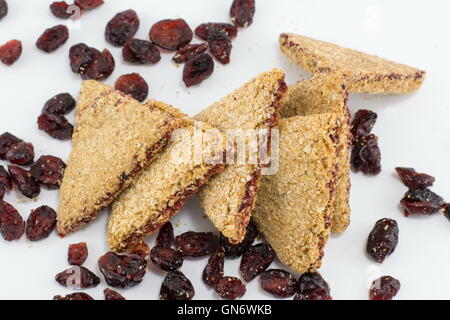Integral triangle cookies with red raisins on white table Stock Photo ...
