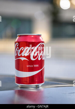 Discarded can of Coca-Cola (coke) amongst other rubbish in a puddle, UK ...