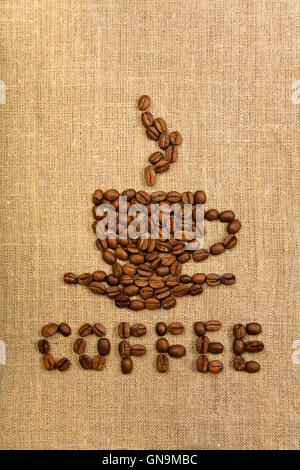 Cup and grain of coffee over textile background Stock Photo - Alamy