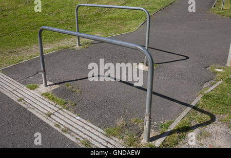Rectangular safety barriers on footpath in housing estate in Bridgend ...