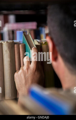 Male student picking a book Stock Photo - Alamy
