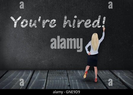 You're hired text write on black board Stock Photo - Alamy