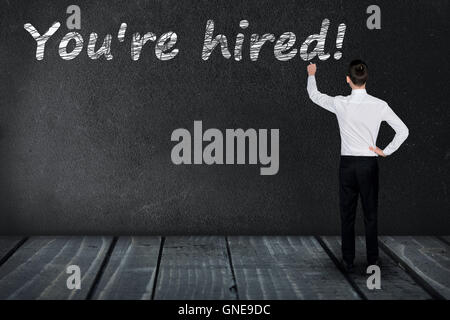 You're hired text write on black board Stock Photo - Alamy