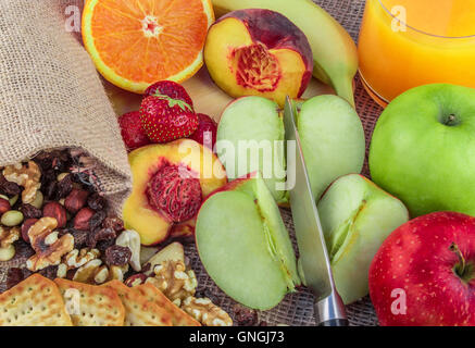Breakfast mix nuts and fruits in wooden bowl and pile on the floor ...