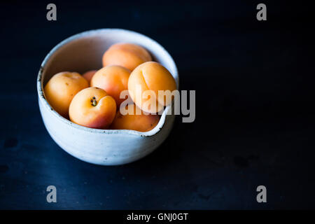 Fresh peaches in a bowl on a steel tray. On a rustic background Stock ...