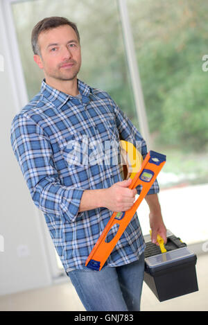 portrait of male builder using spirit level Stock Photo - Alamy