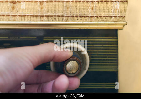 Hand tuning fm radio button. Retro image processed. Hand adjusting ...