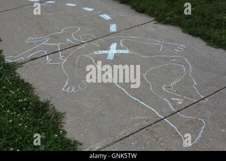 Chalk drawing depicting the outline of an adult and child's bodies ...
