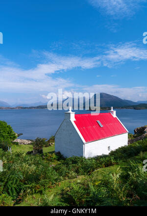 Small cottage with red roof beside Loch Shieldaig in Torridon, on North ...