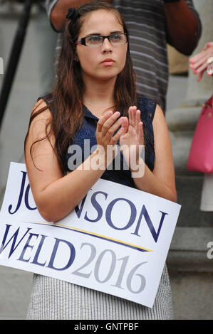 Young brunette woman at political election sitting by ballot smiling ...