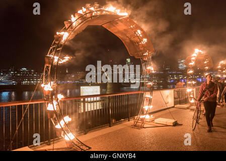 With burning metal structures, cascading candles and flickering ...