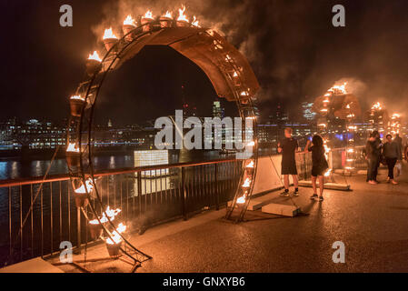 With burning metal structures, cascading candles and flickering ...