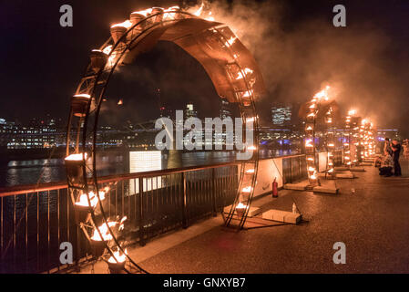 With burning metal structures, cascading candles and flickering ...