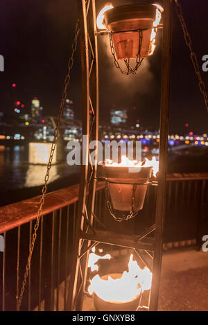 With burning metal structures, cascading candles and flickering ...