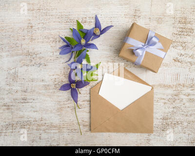 Composition with greeting card in envelope, rose flowers and heart made ...