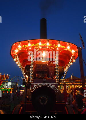 Showmans Traction Engine in front of a steam fairground ride at the ...
