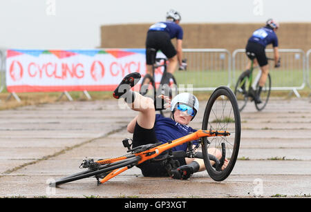 Cyclist falls off the bike on the asphalt road. Accident man in sports ...