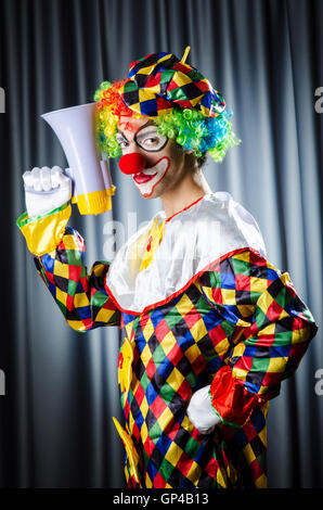 Clown in studio with loudspeaker Stock Photo - Alamy