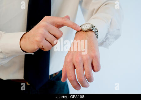 Man's hand pointing his watch. Close view Stock Photo - Alamy