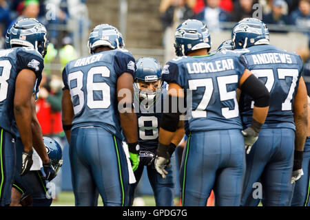 Seattle Seahawks players huddle during warmups before an NFL football ...