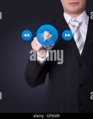 Man pressing media player button Stock Photo - Alamy