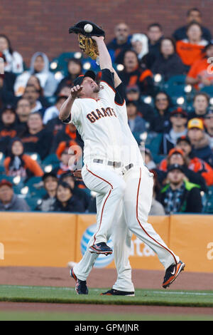San Francisco Giants first baseman Rafael Devers, left, is checked on ...