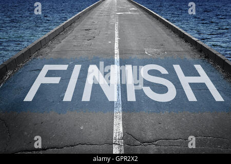 Asphalt road with finish line message Stock Photo - Alamy