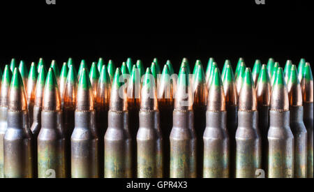 Green tipped rifle bullets that are on a stone background Stock Photo ...