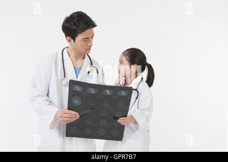 Doctor teaching his daughter medicine Stock Photo - Alamy
