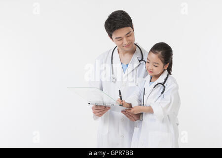 Doctor teaching his daughter medicine Stock Photo - Alamy
