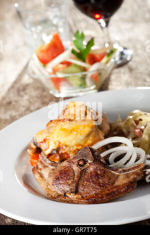 grilled lamb chop with onion, tomato and aubergine Stock Photo - Alamy