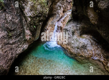small turquoise river flowing into the sea at sunset and silk effect ...
