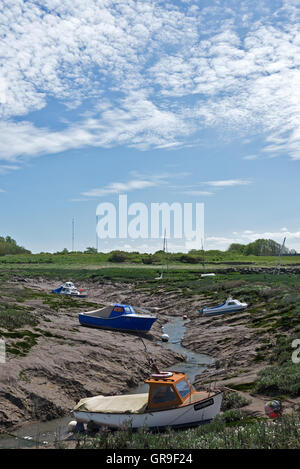 Boats moored in the creeks leading through the estuary of Blind Yeo and ...