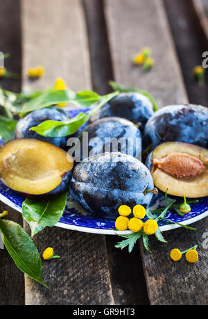 Fresh ripe plum on a wooden background Stock Photo - Alamy