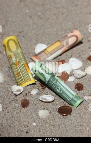money and shells in the sand, symbol image travel expenses Stock Photo ...