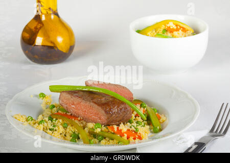 Lamb On Rice With Carrots And Peas Stock Photo - Alamy