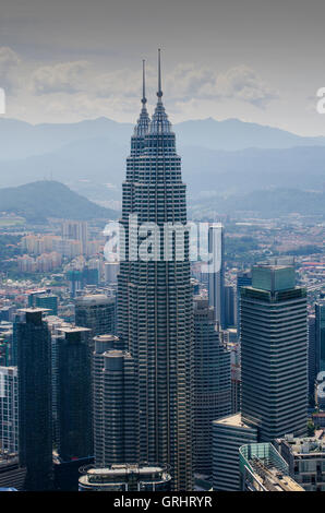 Top most floor of the Petronas Twin Tower building emerging from thick ...
