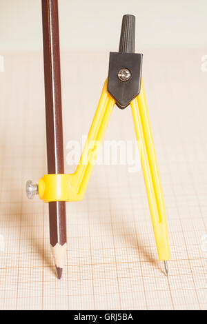 Drawing compass on graph paper Stock Photo - Alamy