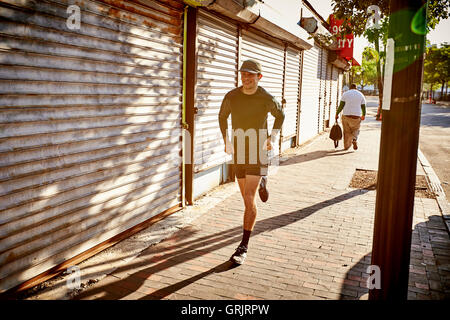 A male runner running through the city Stock Photo - Alamy