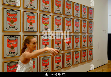 Visitors in front of Campbell's Soup Cans (1962) by Andy Warhol in ...