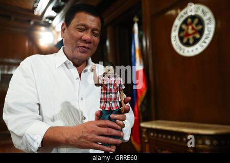 Philippine President Rodrigo R. Duterte smiles as he views two custom ...