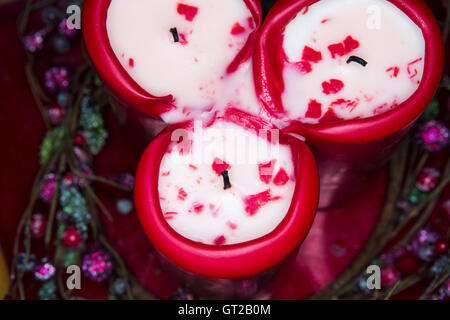 Unlit melted red wax candle in a handmade candle holder. Close everyday ...