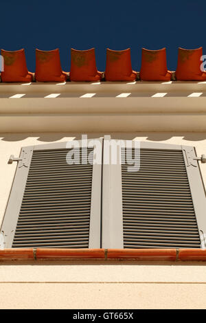 Closed shuttered windows on a whitewashed house in the sun Stock Photo ...