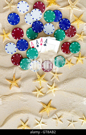 Gambling on vacation concept - white sand with seashells , colored ...