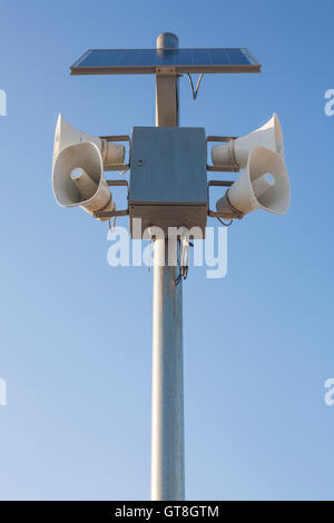 Solar-powered megaphones pole against blue sky background Stock Photo ...
