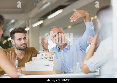 Architects discussing model in meeting Stock Photo - Alamy
